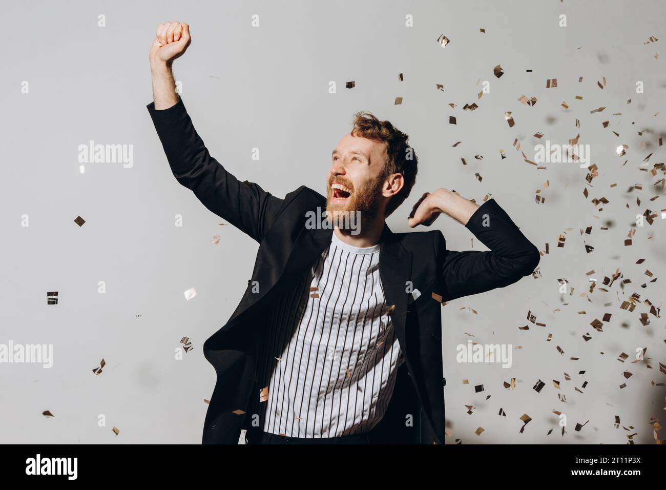 Concept of celebration and victory. Stylish young man isolated on white ...
