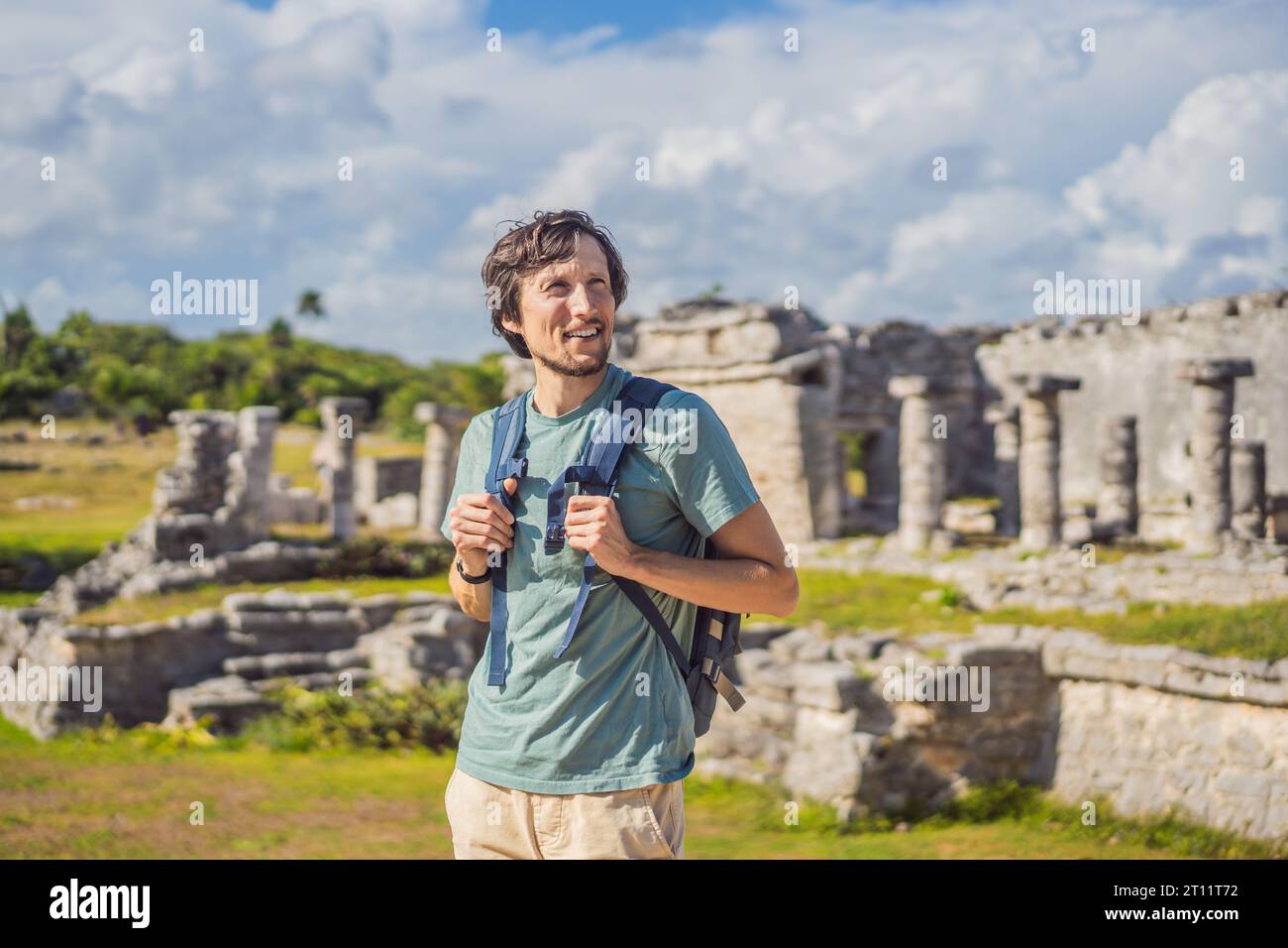 Male tourist enjoying the view Pre-Columbian Mayan walled city of Tulum ...