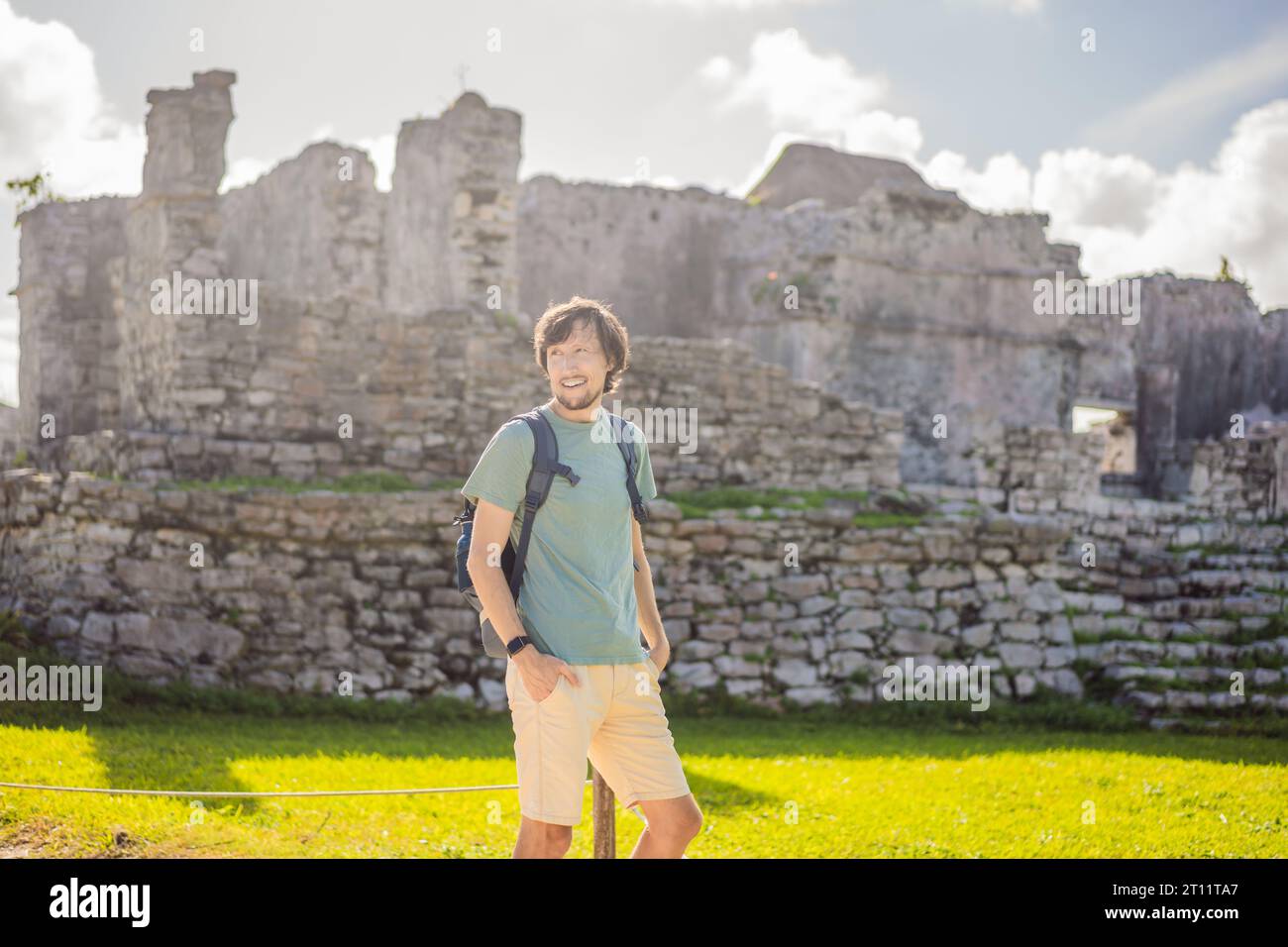 Male tourist enjoying the view Pre-Columbian Mayan walled city of Tulum ...