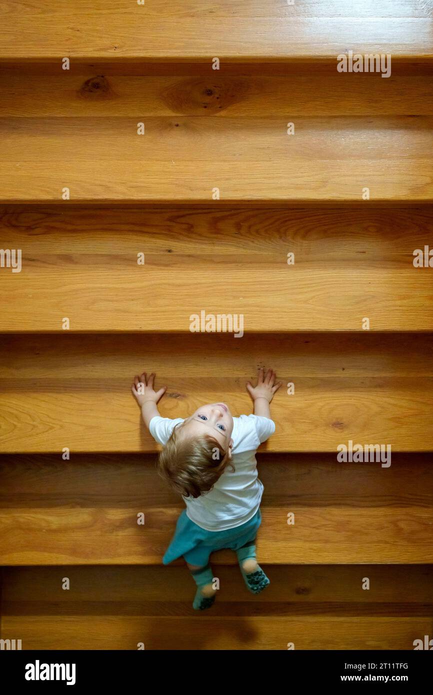 Baby preparing himself to courageously climb a flight of stairs Stock ...