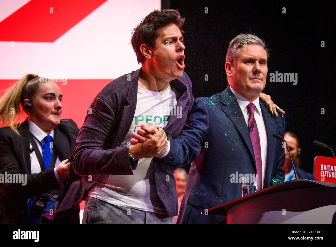 London, UK. 10 October 2023. A protester throws glitter over Labour ...