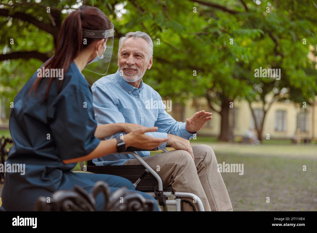 Talkative aged man, recovering patient in wheelchair having ...