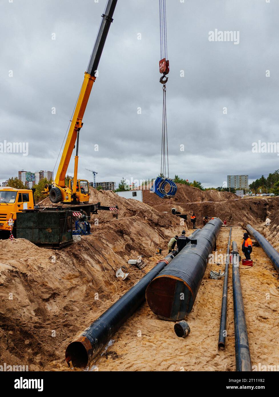 Process of laying and joining of water supply or sewer pipes. Lifting ...