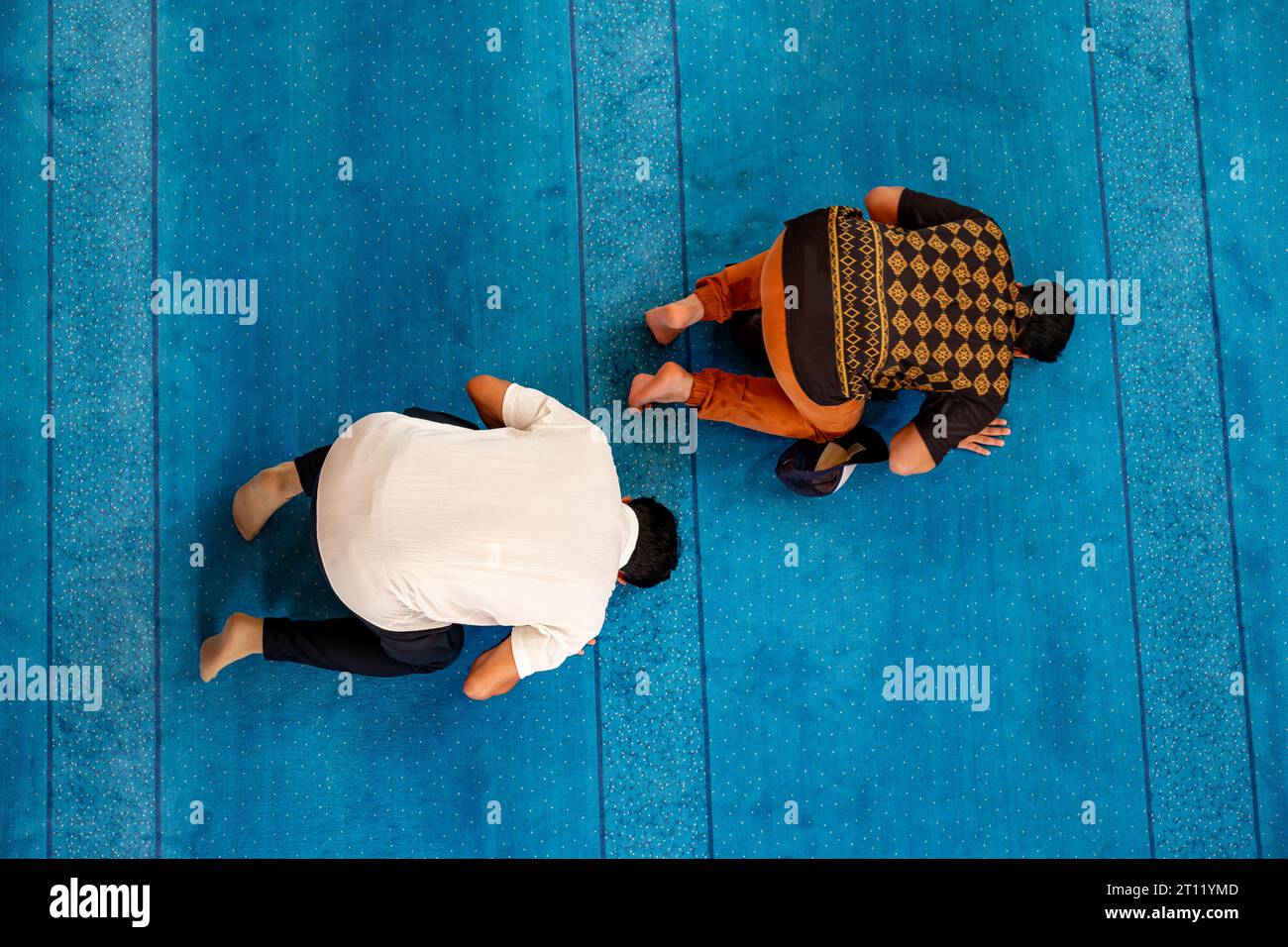 Top view of adults praying inside masjid and Prostration in prayer ...
