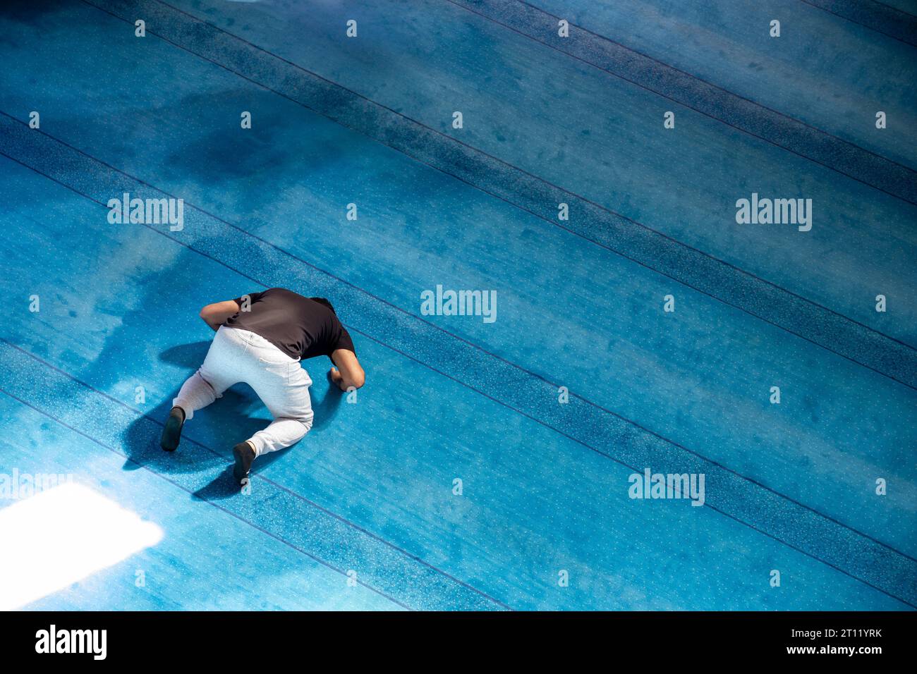 Top view of adults praying inside masjid and Prostration in prayer ...
