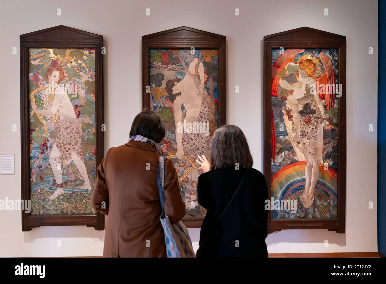 Visitors look at embroidered works by Phoebe Anna Traquair in the new ...