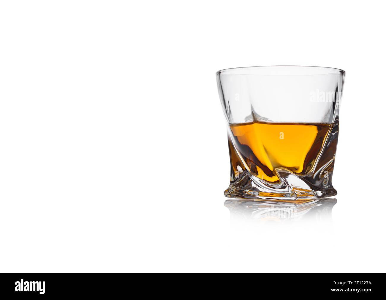 Scotch whiskey in crystal modern luxury glass on white background with ...