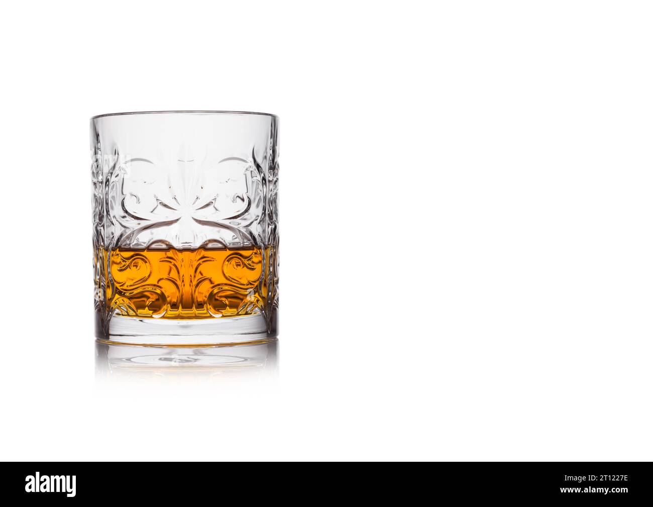 Scotch whiskey in crystal elegant glass on white background with ...