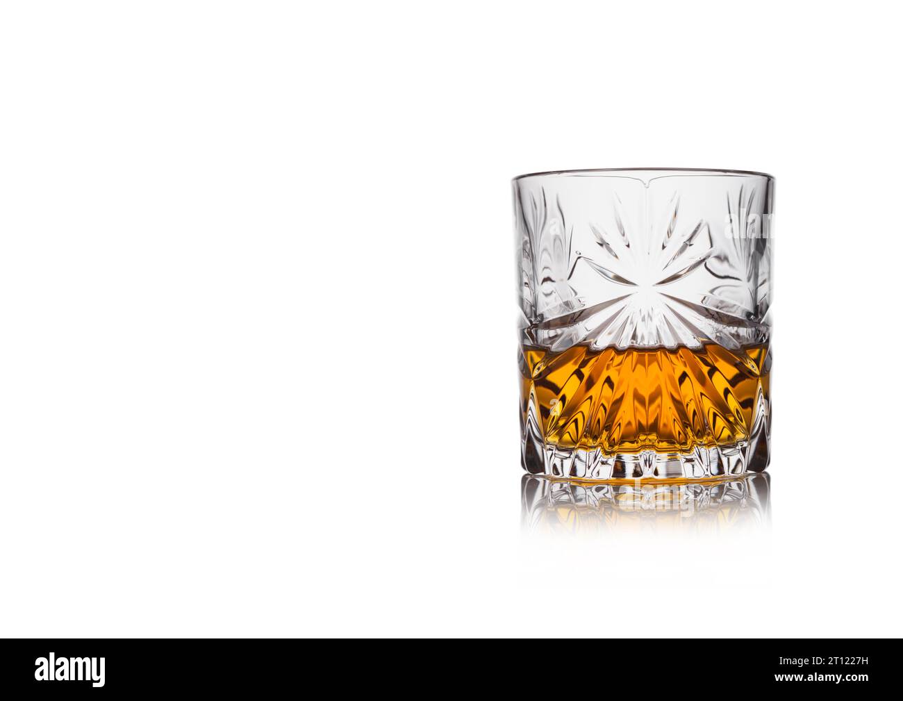 Scotch whiskey in crystal elegant glass on white background with ...
