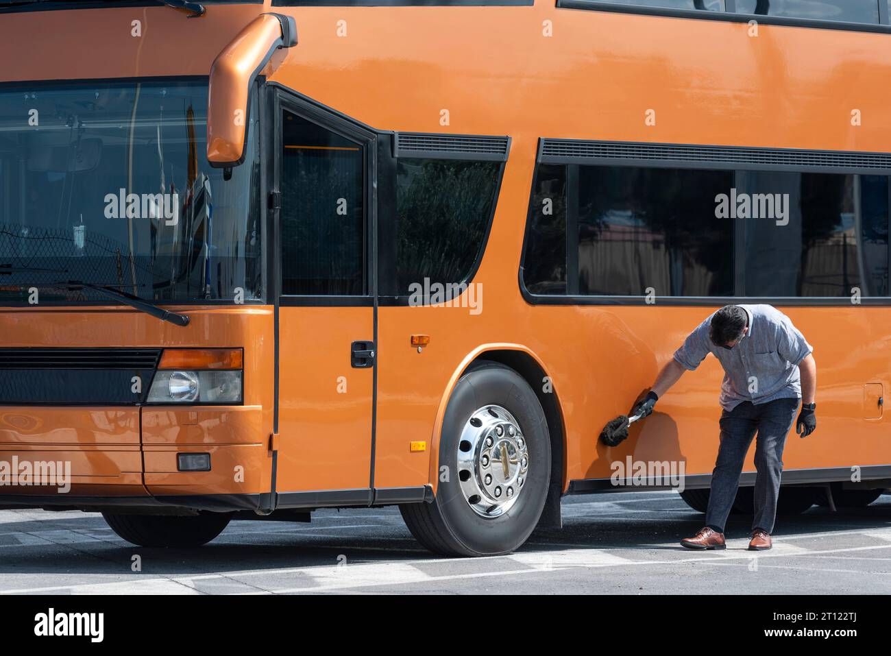 Herkalion, Crete, Greece. 2 Oct 2023. Bus driver cleaning and polishing ...