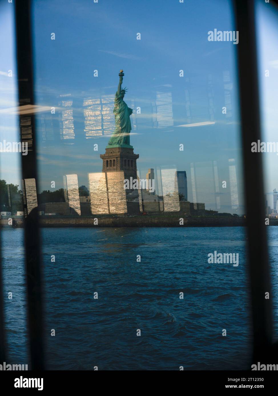 The Statue of Liberty New York seen through the window of a ferry Stock ...