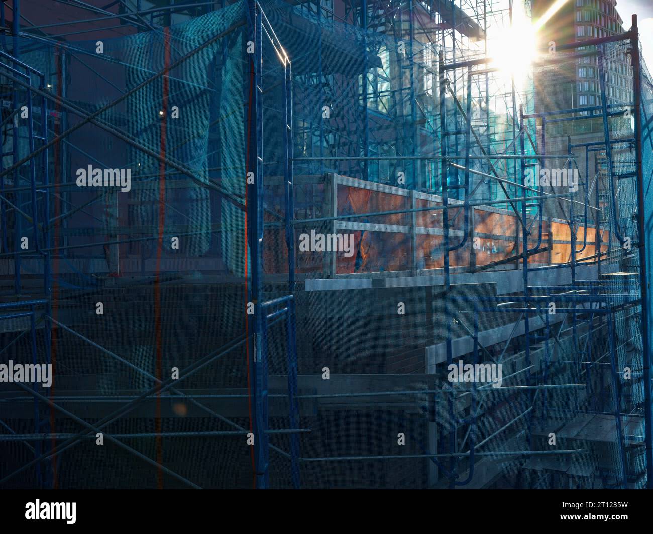 netting or mesh covering scaffolding on a building under construction ...