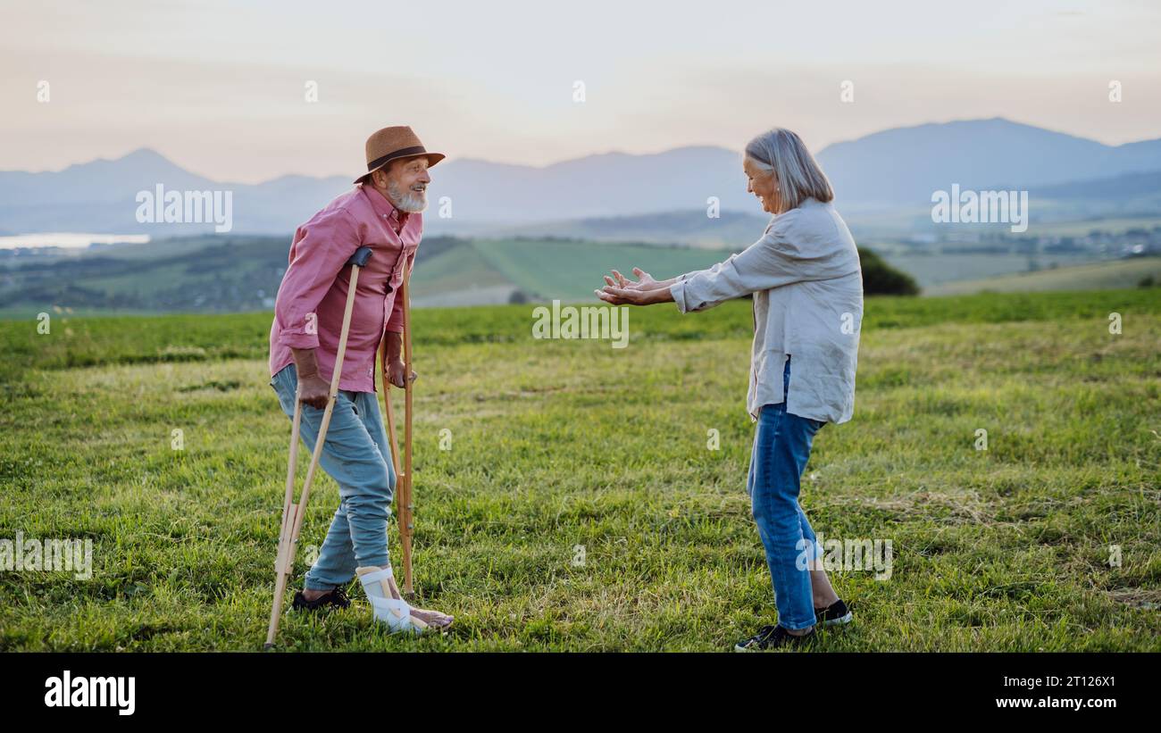 Senior man with broken leg and crutches. Recovery, rehabilitation after ...