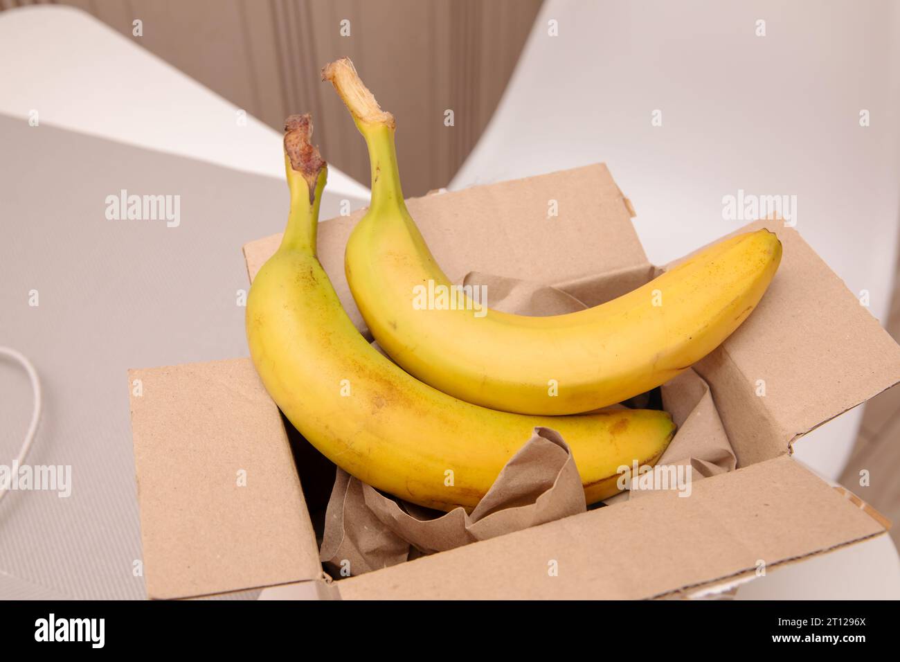 Banana fruit in a brown paper recycled box Stock Photo - Alamy