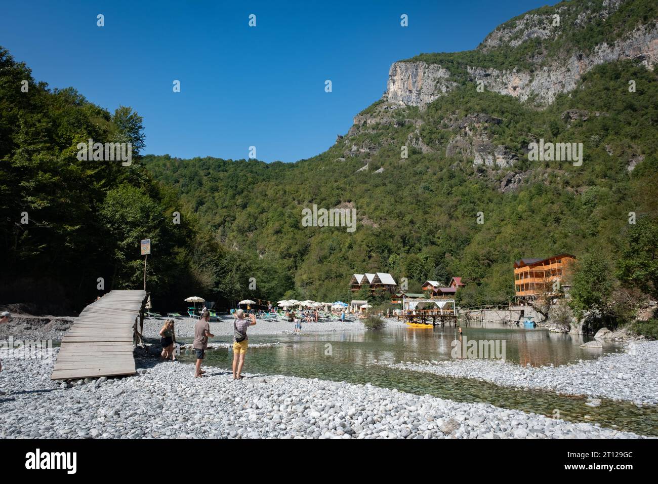 Visitors taking photos at River Shala resort near Lake Komani, Albania ...