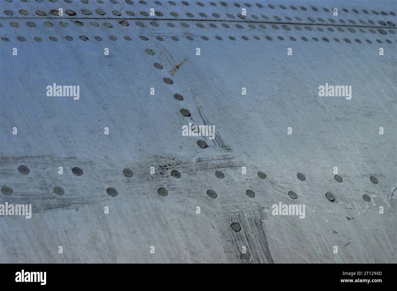 Metallic background with studs. Fragment of an old airplane fuselage ...