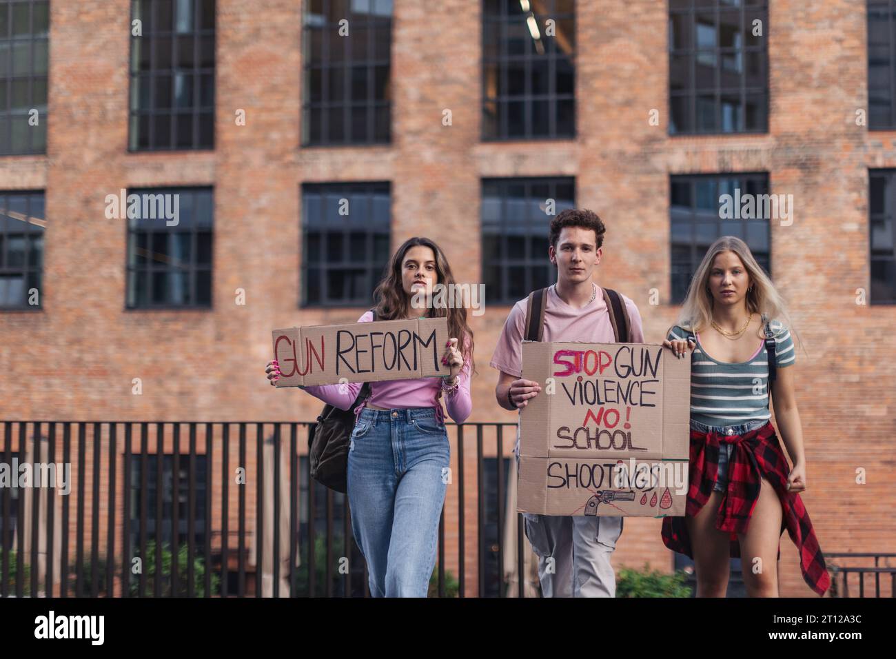 Generation Z activists with banners protesting on the street. Young ...