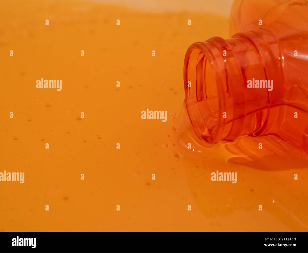 Liquid shower gel gracefully pours from a container onto a bright ...