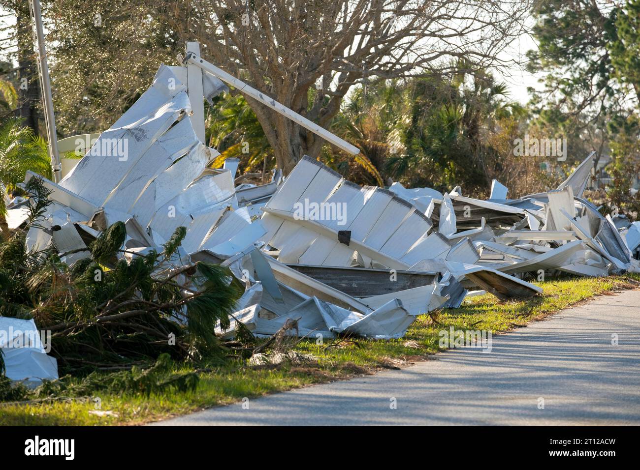 Scrap metal disposed in heaps on street side after hurricane severely ...