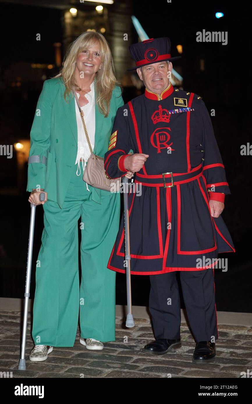 Penny Lancaster with a Yeoman Warder as she attends the launch of Geri ...