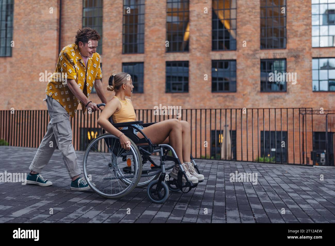 Beautiful gen Z girl in wheelchair with her boyfriend. Inclusion ... Beautiful gen Z girl in wheelchair with her boyfriend. Inclusion ...