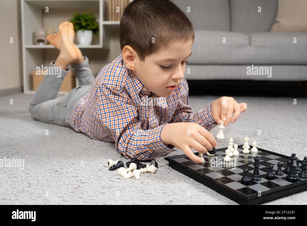 Little boy playing chess. Board games for children Stock Photo - Alamy