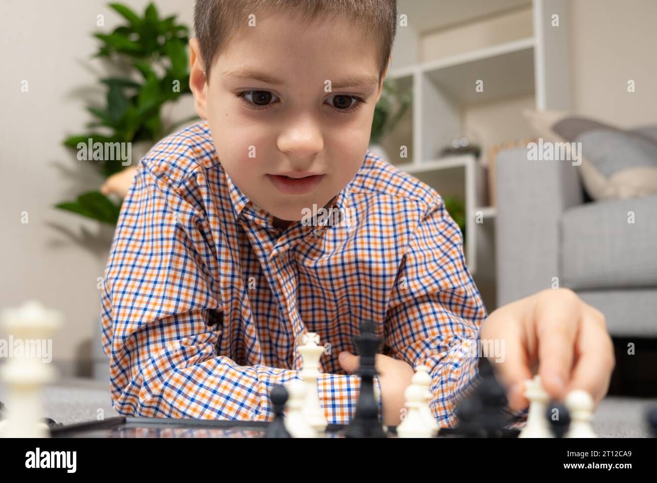 Little boy playing chess. Board games for children Stock Photo - Alamy