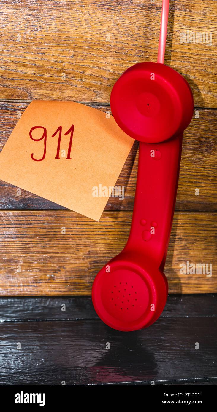Writing 911 on memo post reminder. sticky paper with text 911 and ...