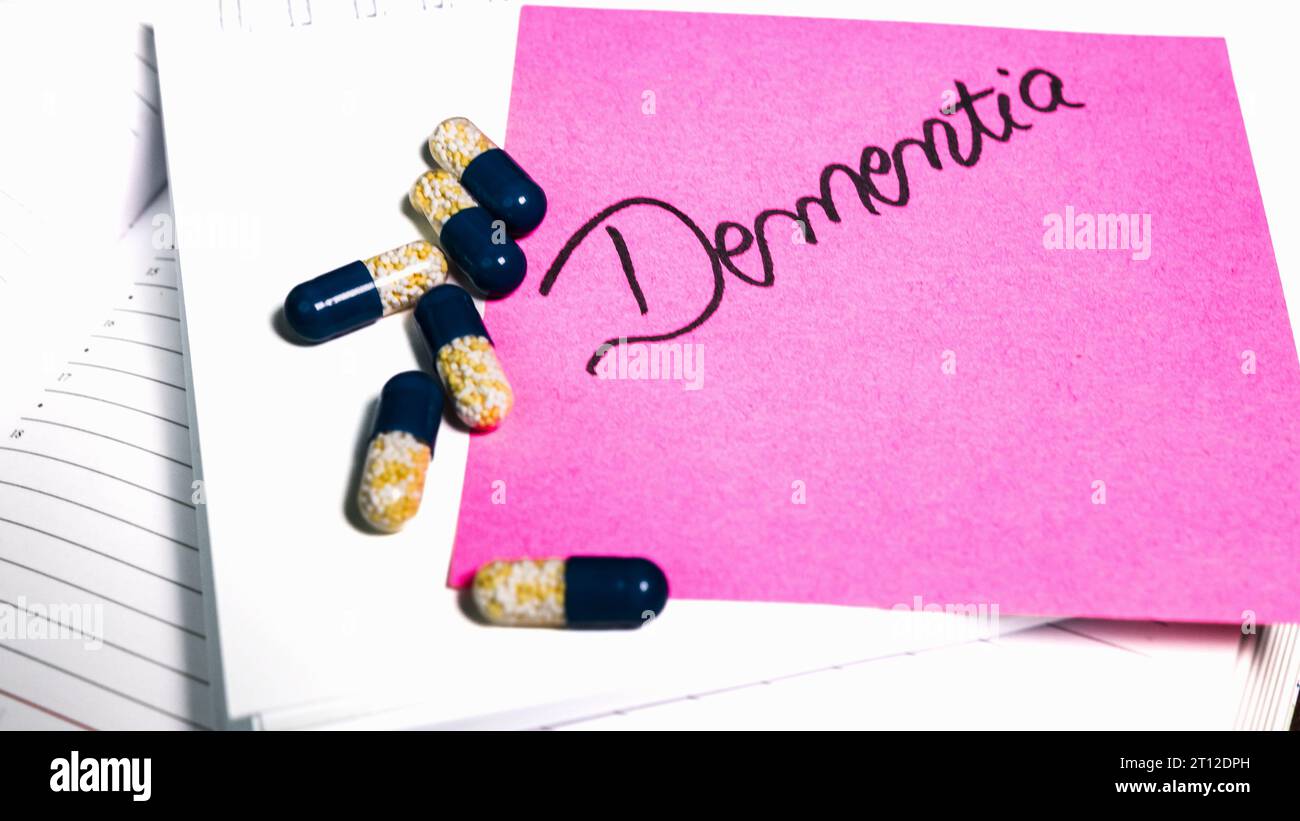 Writing Dementia on memo post reminder and medicines, pills. Writing ...