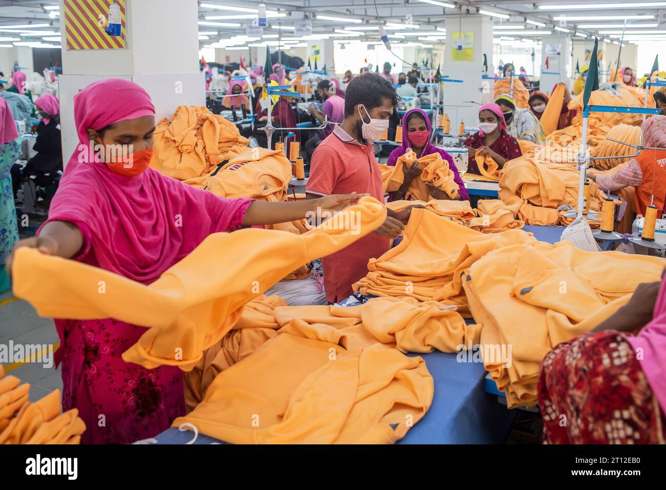Garment workers work at the Surma Garments Limited in Savar Stock Photo ...