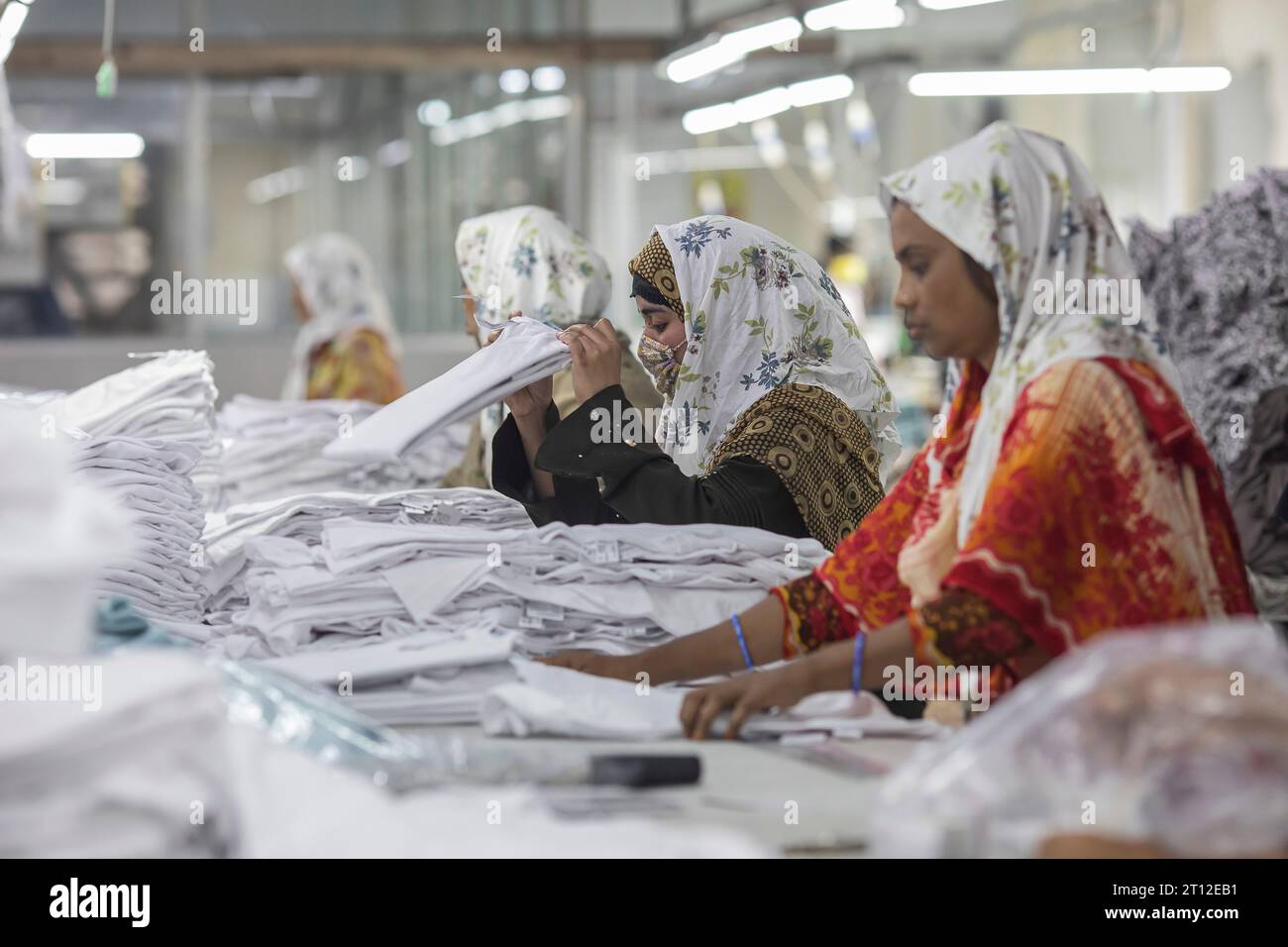 Garment workers work at the Surma Garments Limited in Savar Stock Photo ...