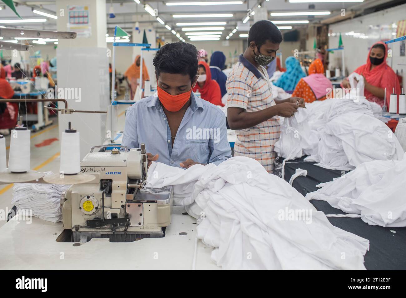 Garment workers work in a sewing section at the Surma Garments Limited ...