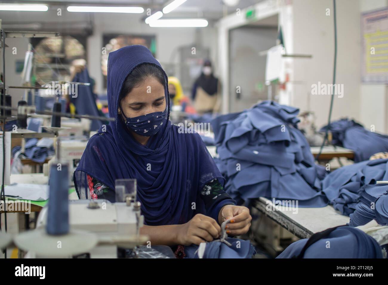A garment worker works in a sewing section at the Surma Garments ...