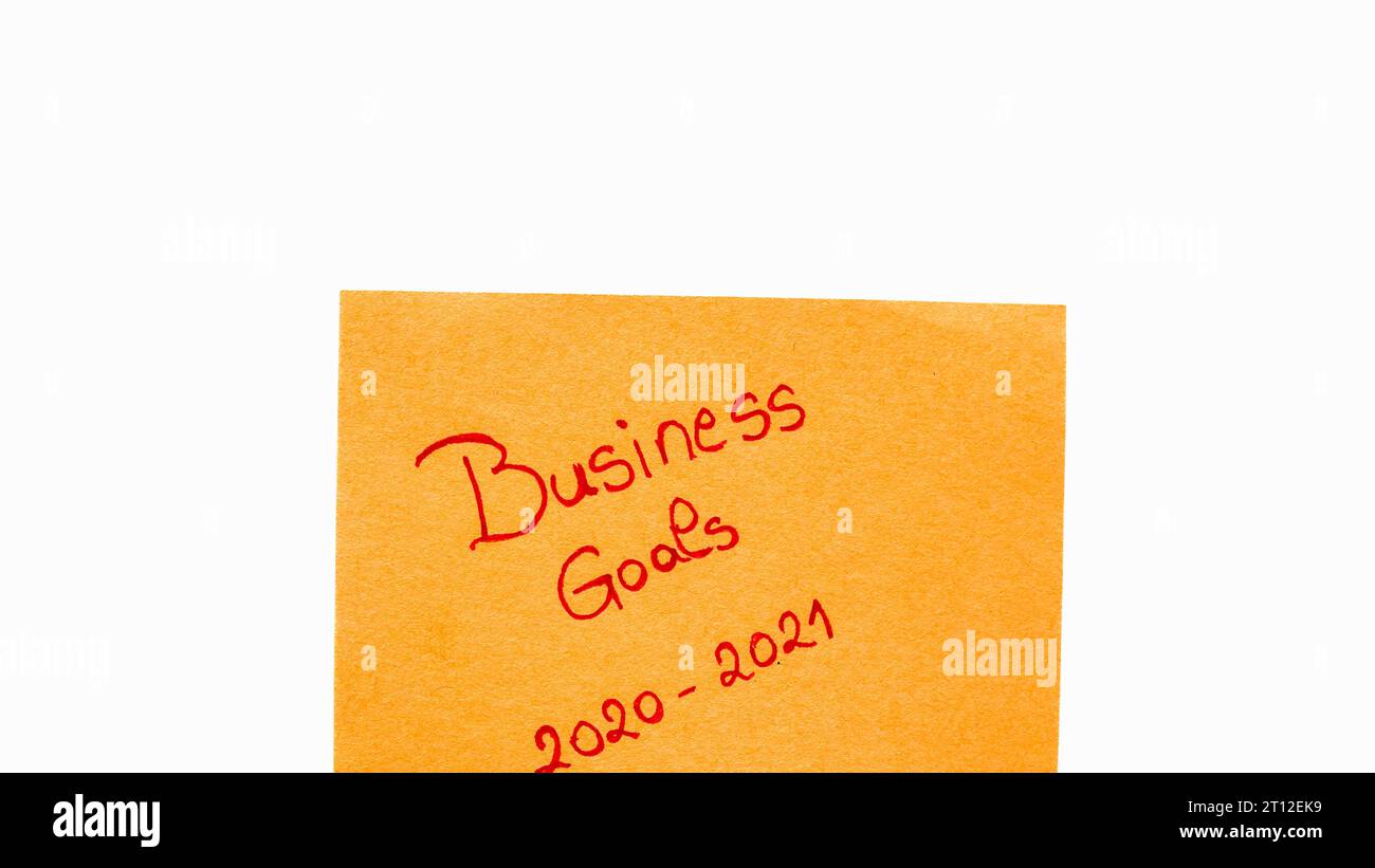 Business goals 2020-2021 handwriting text close up isolated on orange ...
