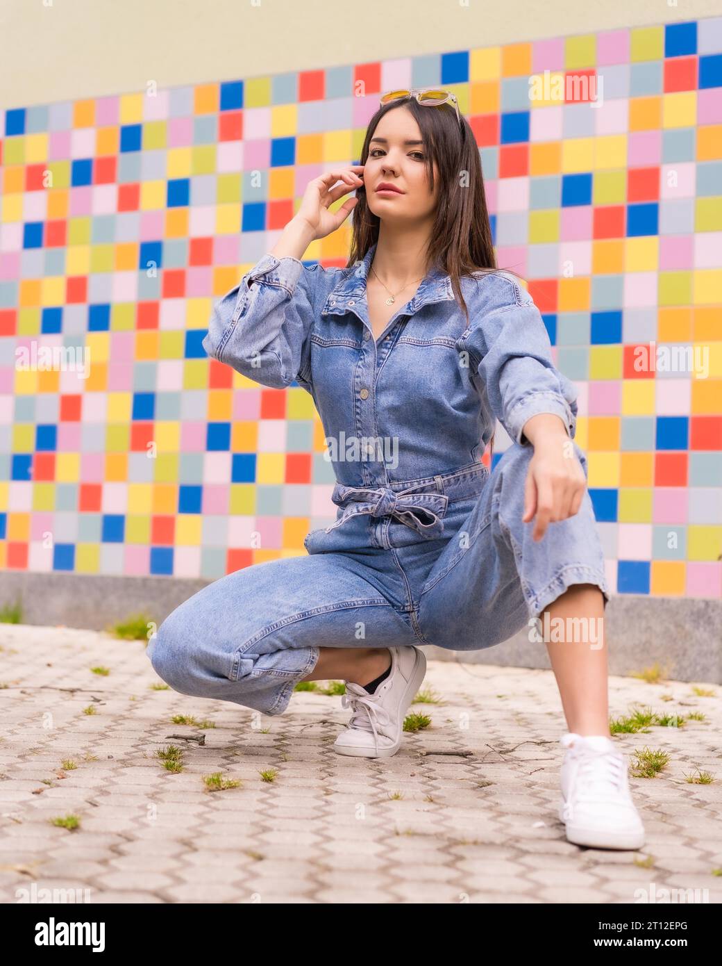 Young caucasian girl with a monkey cowboy in colored tiles. Enjoying ...