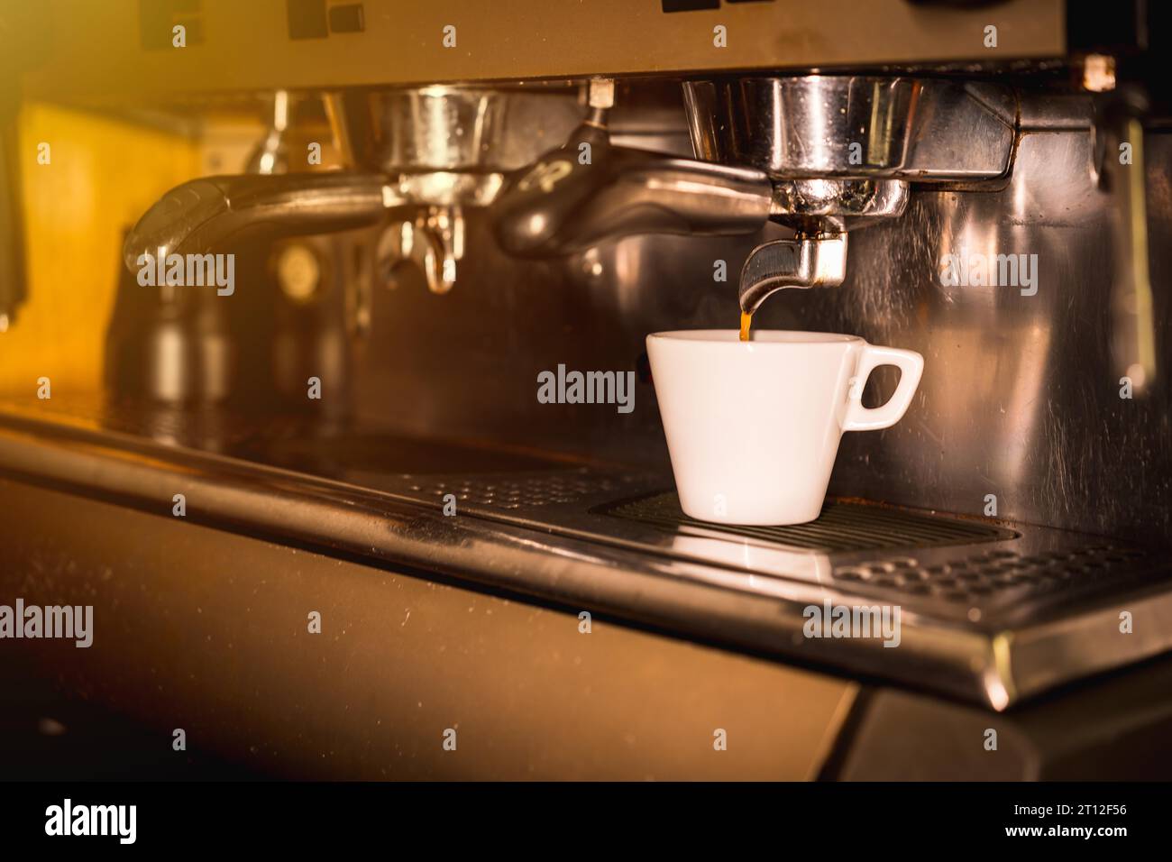 Coffee machine putting a decaf in a white cup Stock Photo - Alamy