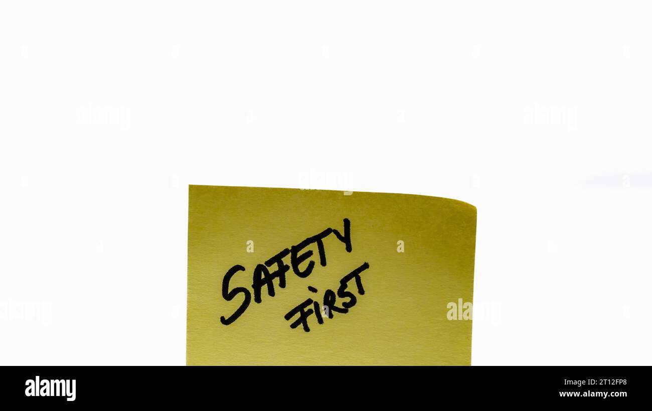 Safety first handwriting text close up isolated on yellow paper with ...