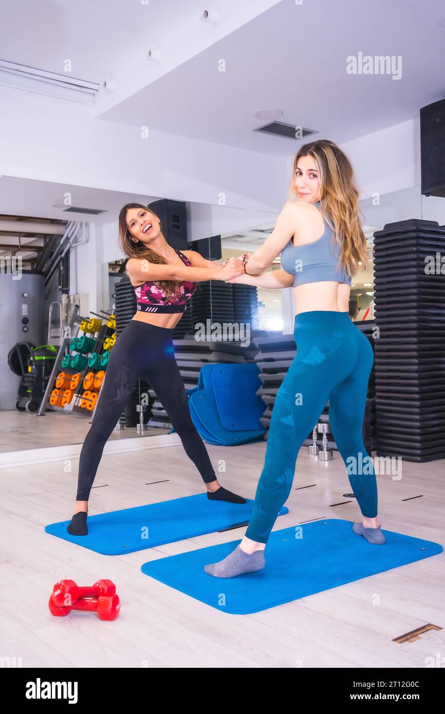 Two pretty girls exercise together hi-res stock photography and images ...