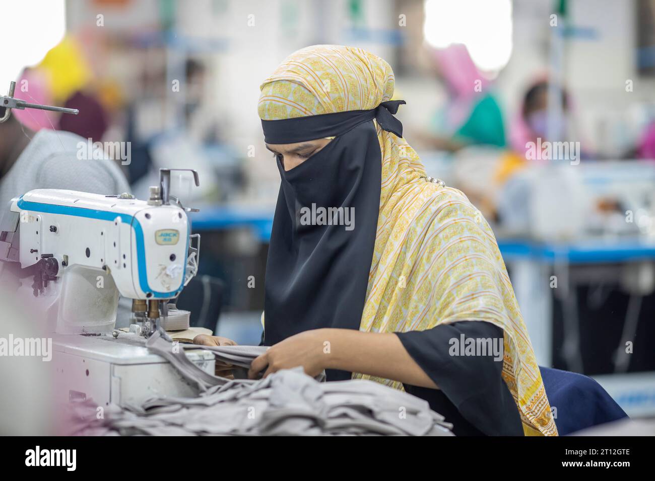 Dhaka, Bangladesh. 10th Oct, 2023. A garment worker works in a sewing section at the Surma ...