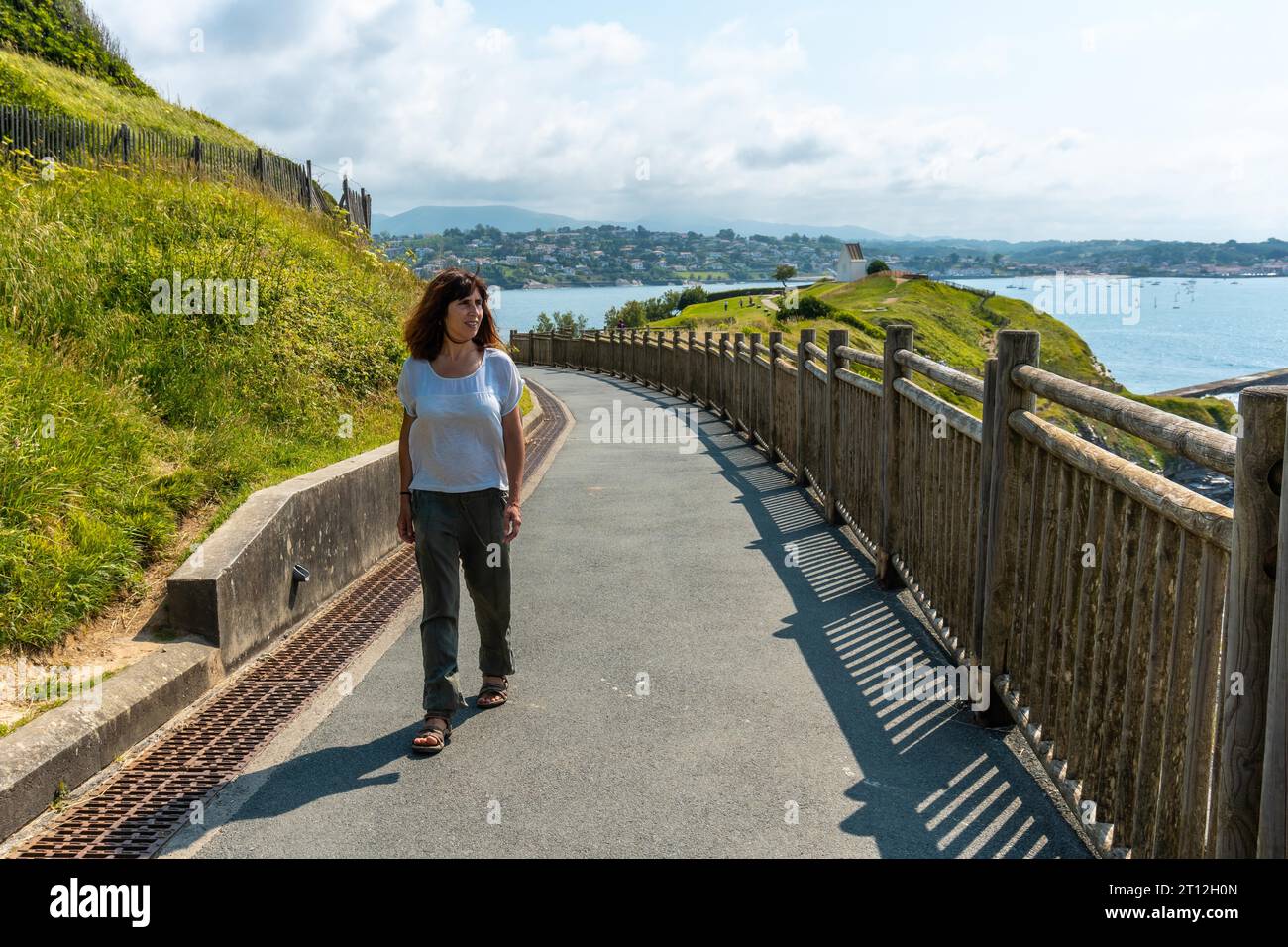 A young woman walking in the natural park of Saint Jean de Luz called ...