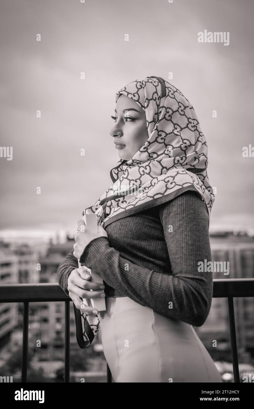 Portrait of an Arab girl with a white veil at the computer on the ...