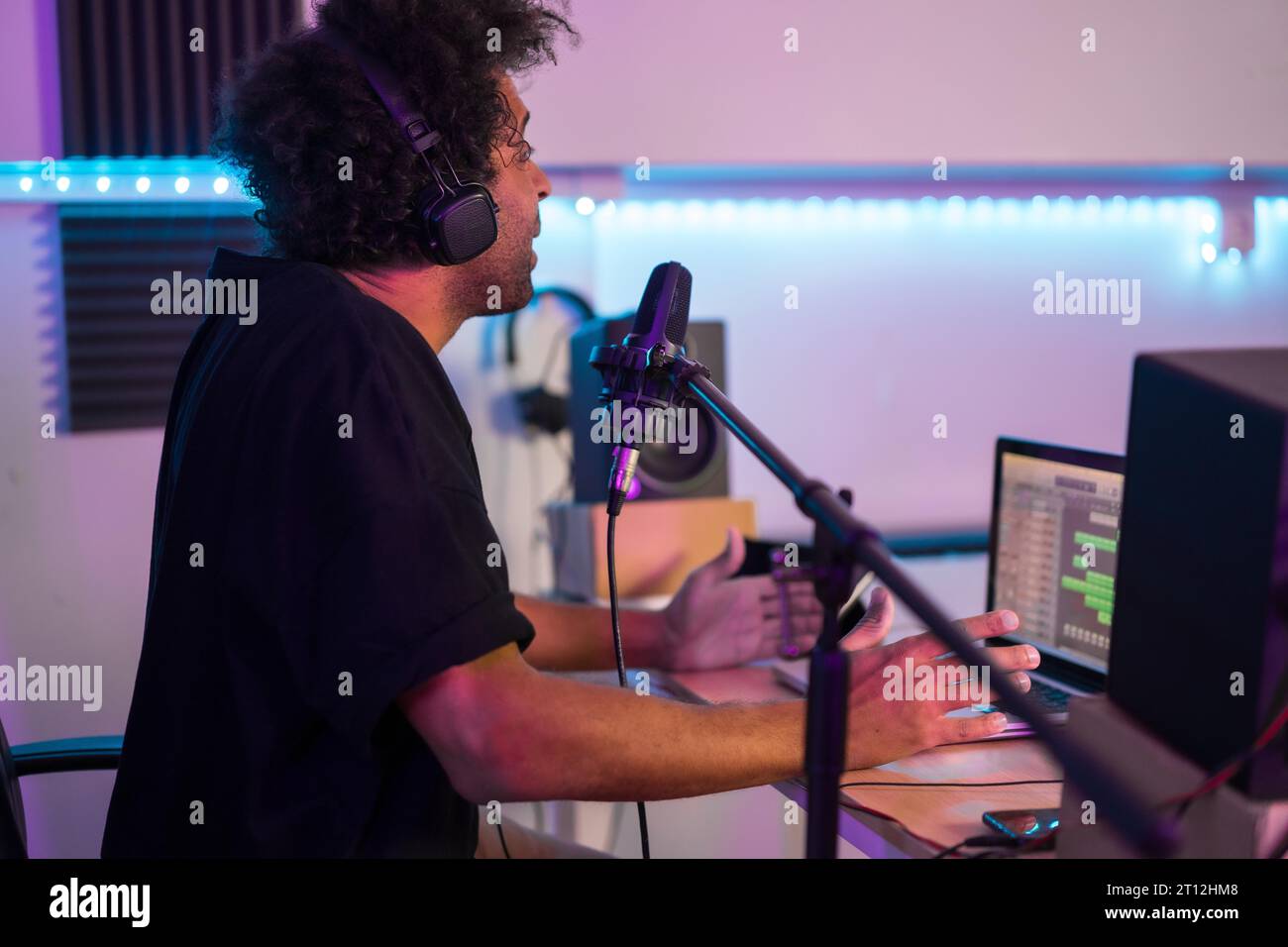 Side view of a musician recording a podcast from a studio Stock Photo ...