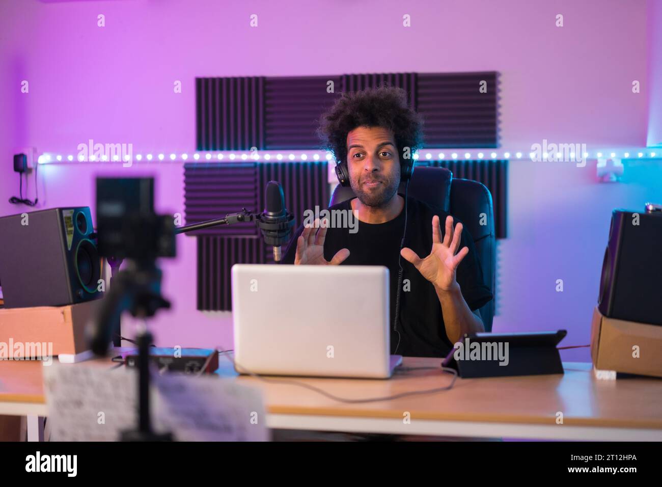 Frontal portrait of a influencer recording a video tutorial in a music ...