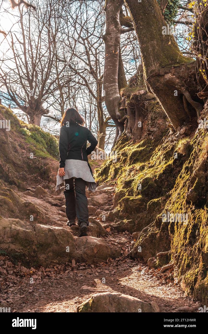 A young girl in the mud ramps of the trail of Mount Adarra in Guipuzcoa ...