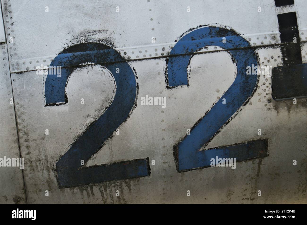 The number 22 on the fuselage of an old airplane. Number 22 written in ...