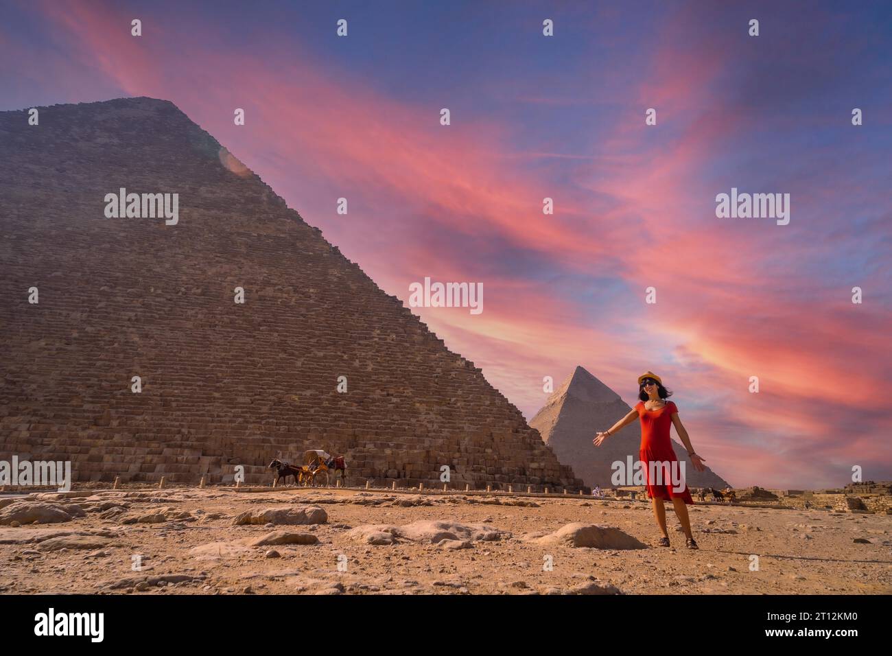 A young girl in a red dress at the pyramid of Cheops the largest ...