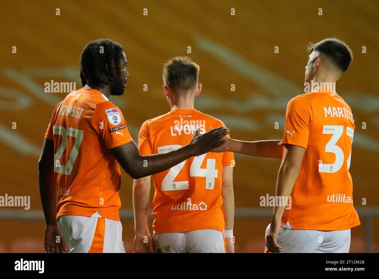 Luke Mariette #37 of Blackpool reacts with Kylian Kouassi #27 of ...