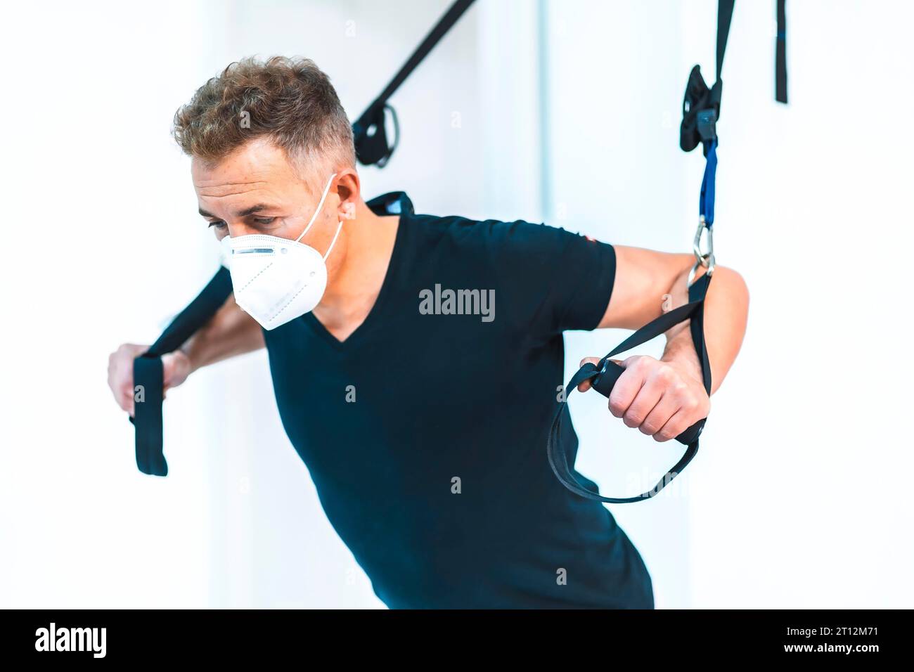 Patient with mask doing stretching. Reopening with security measures of ...