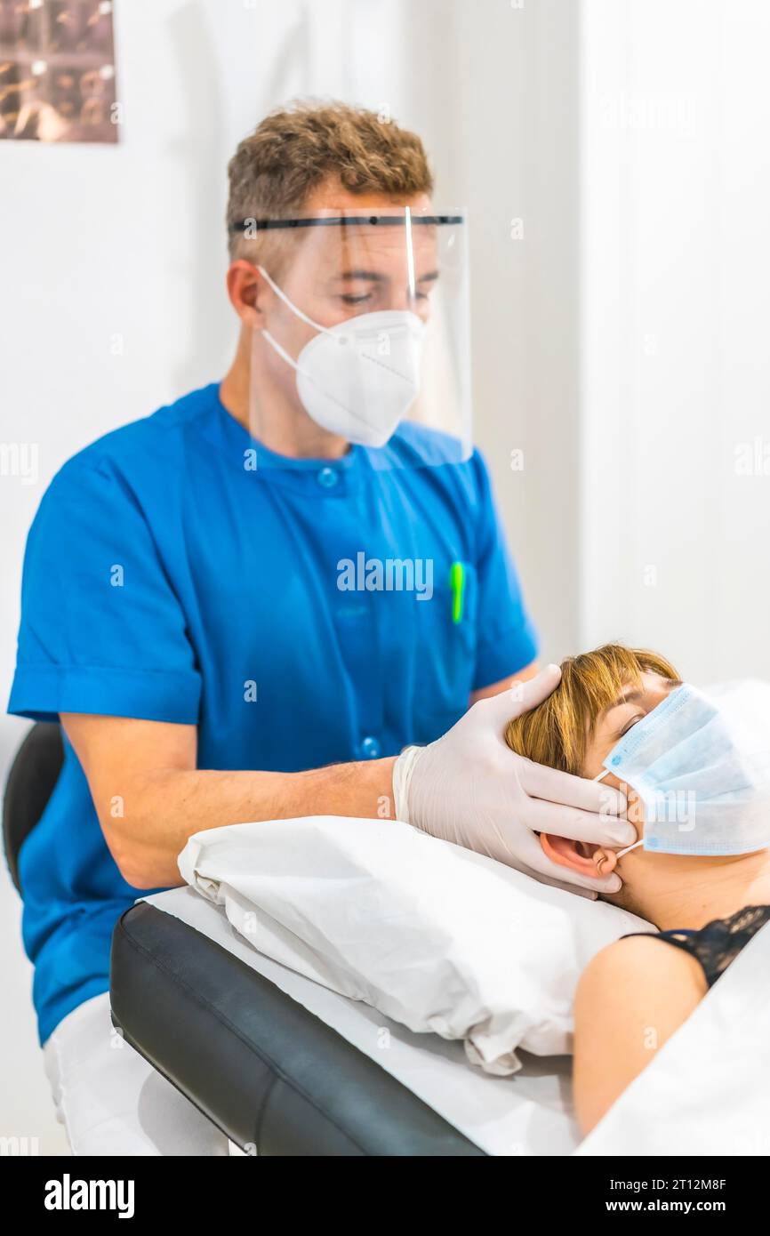 Cranial massage on the head of a physiotherapist with protective ...