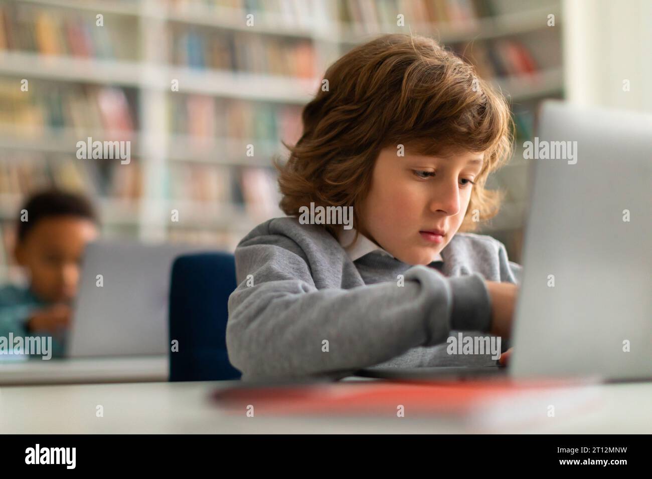 School kids at desks using laptops in the classroom Stock Photo - Alamy